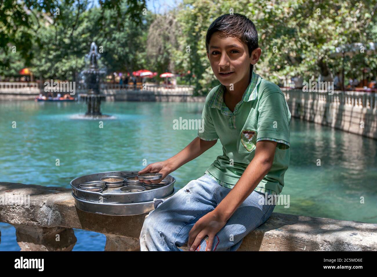 A Kurdish boy selling fish pellets sits at Ayn-i Zeliha, the second ...