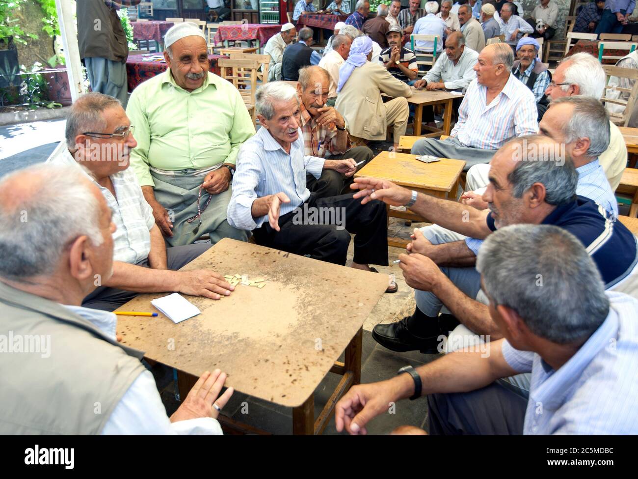 Kurdish men engage in conversation in the tea garden inside the ...