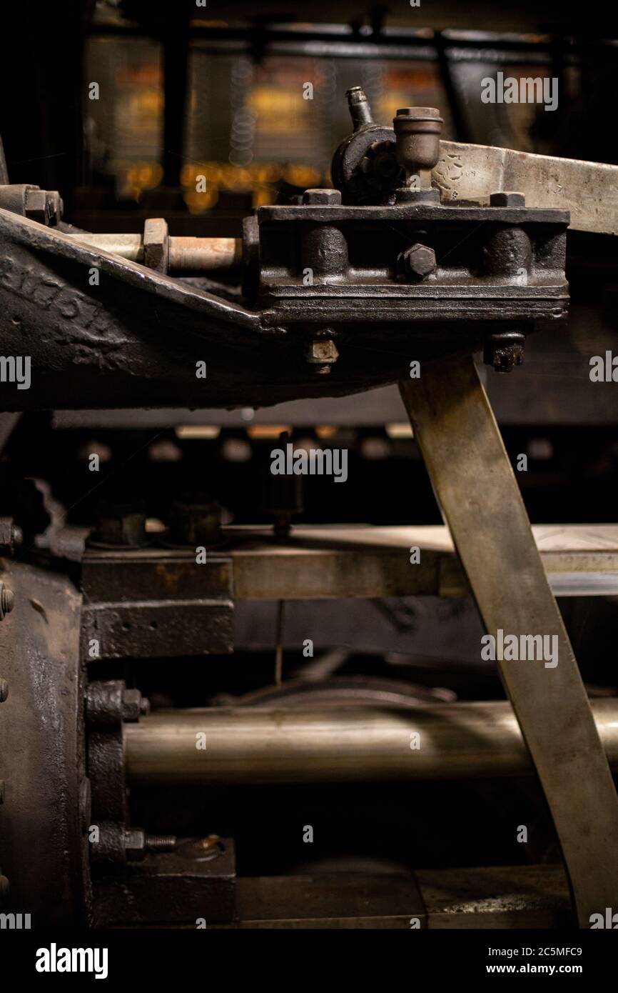 Rusty old valves, gauges and metal parts on an antique steam locomotive ...