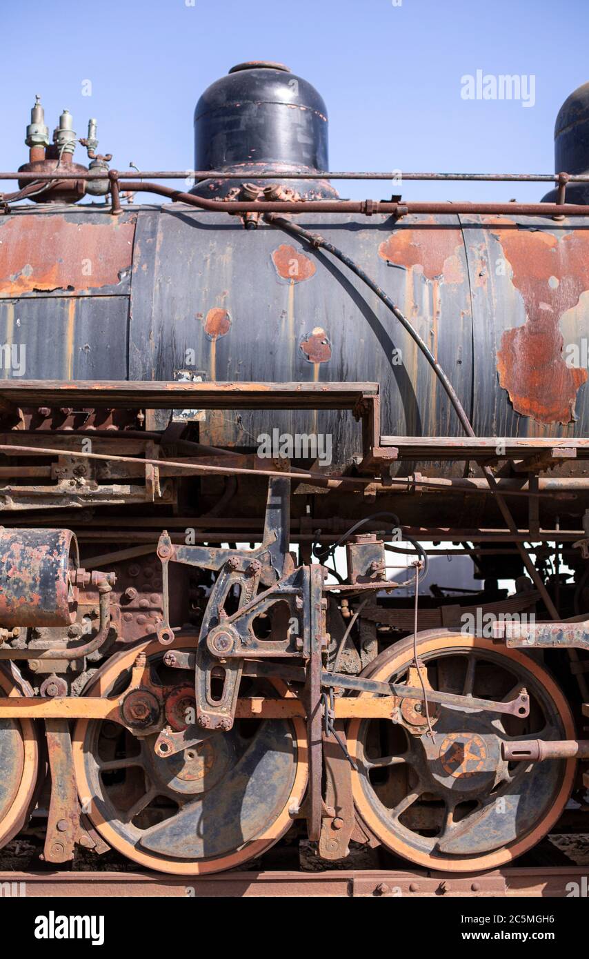 Rusty old valves, gauges and metal parts on an antique steam locomotive ...