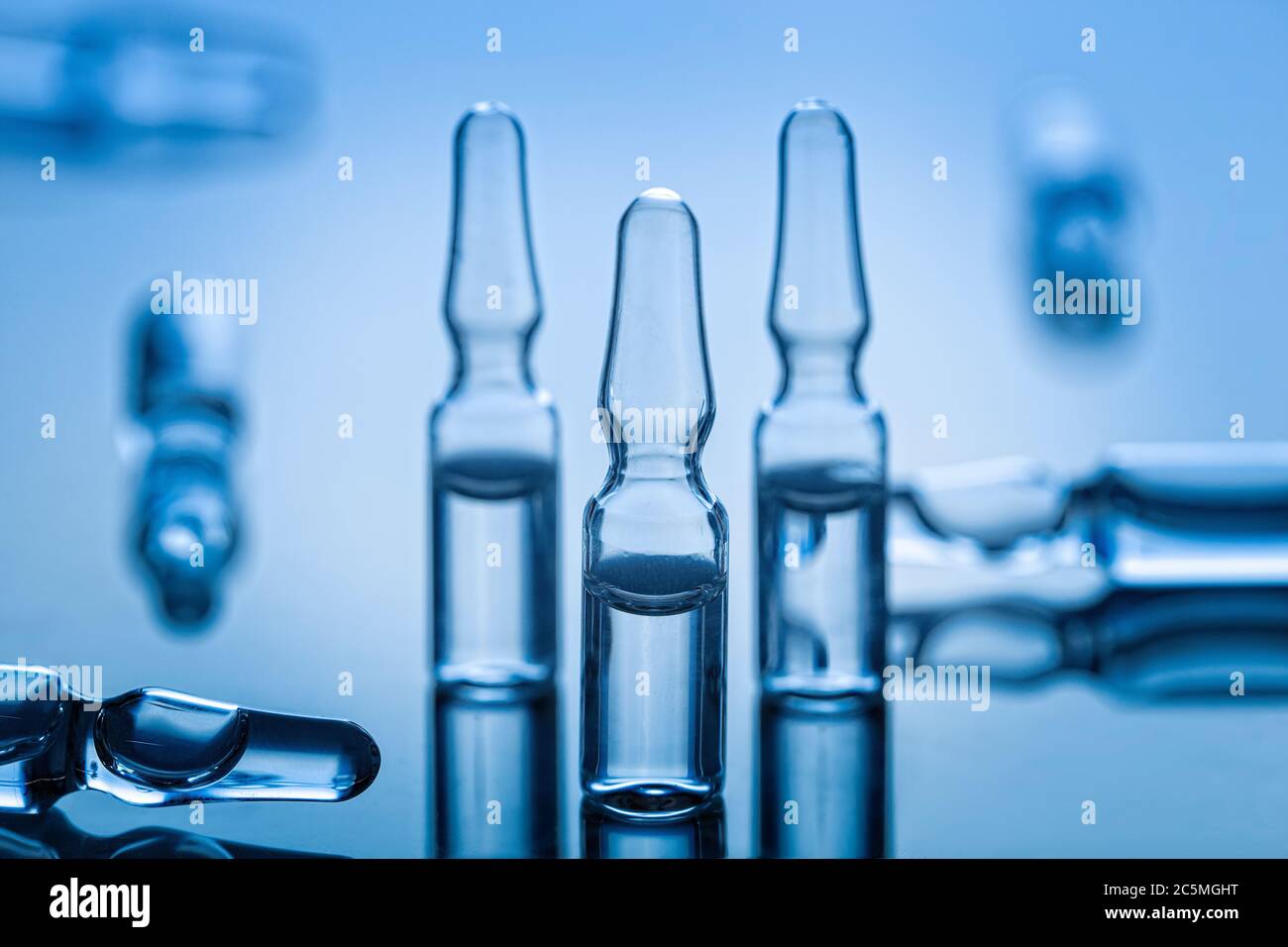 Groupe of medical glass ampules on blue background Stock Photo - Alamy