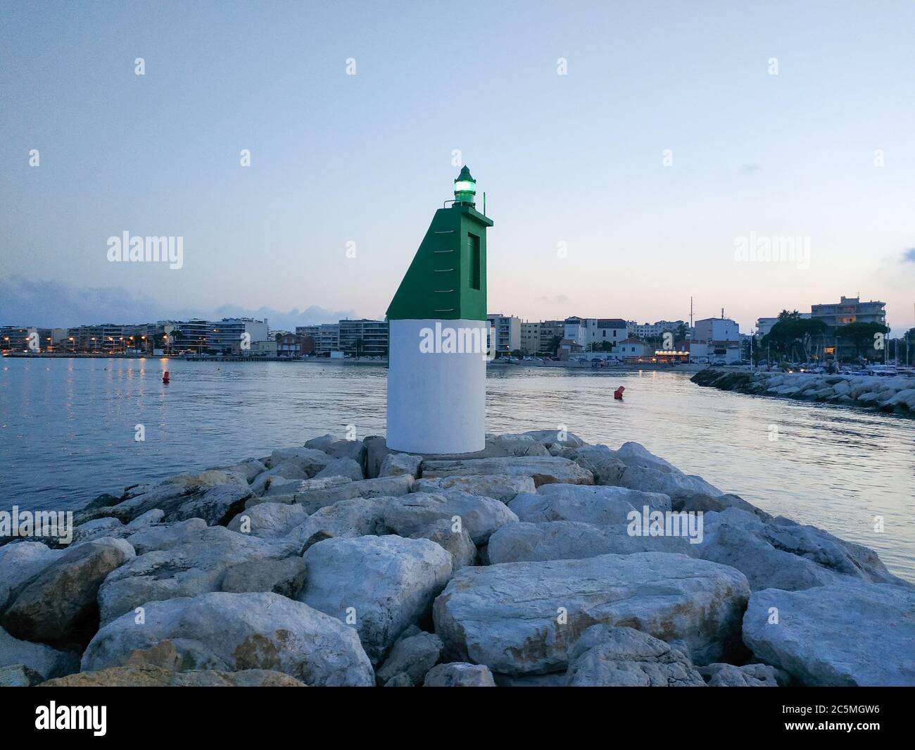 Small lighthouse in the port of Cannes, France Stock Photo - Alamy