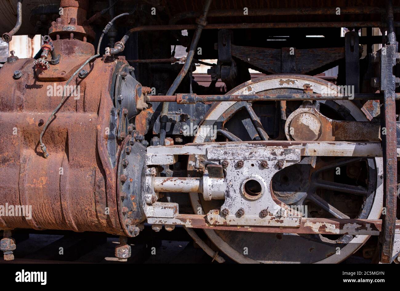 Rusty old valves, gauges and metal parts on an antique steam locomotive ...