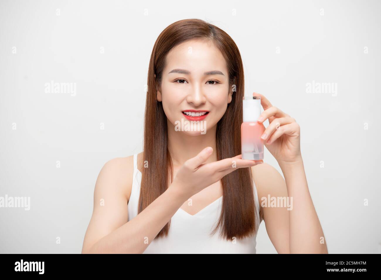 Beautiful Young Asian Woman with short hair Holding cosmetic product ...