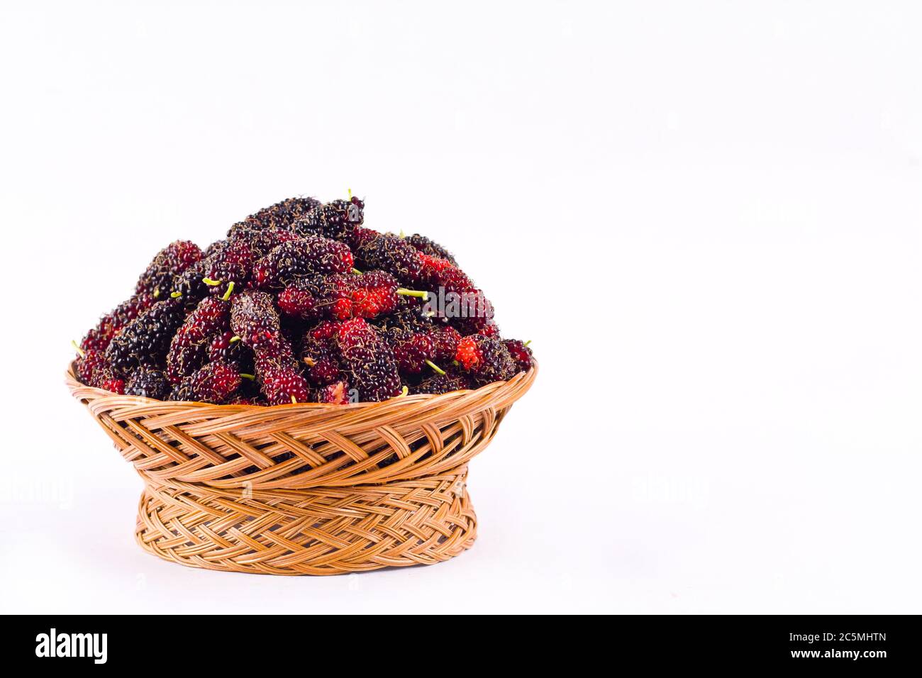 fresh organic mulberries in brown basket on white background healthy ...