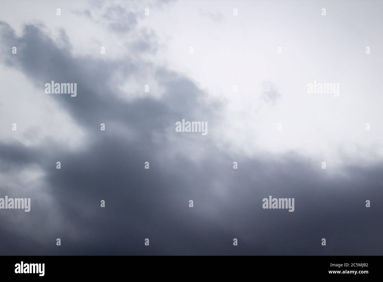 A beautiful stormy sky with clouds. The Dark heavy thunderstorm clouds before the rain. Dramatic ...