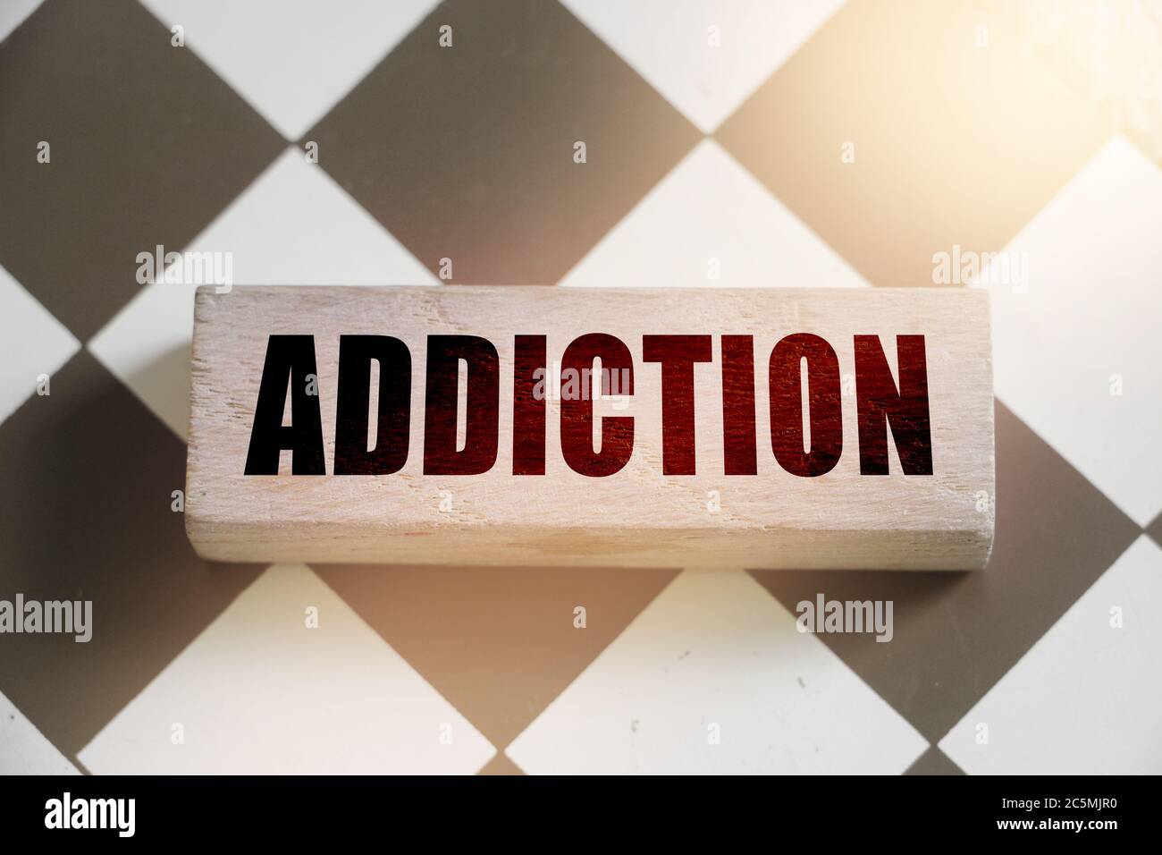 ADDICTION word written on wooden building block put on chess board ...