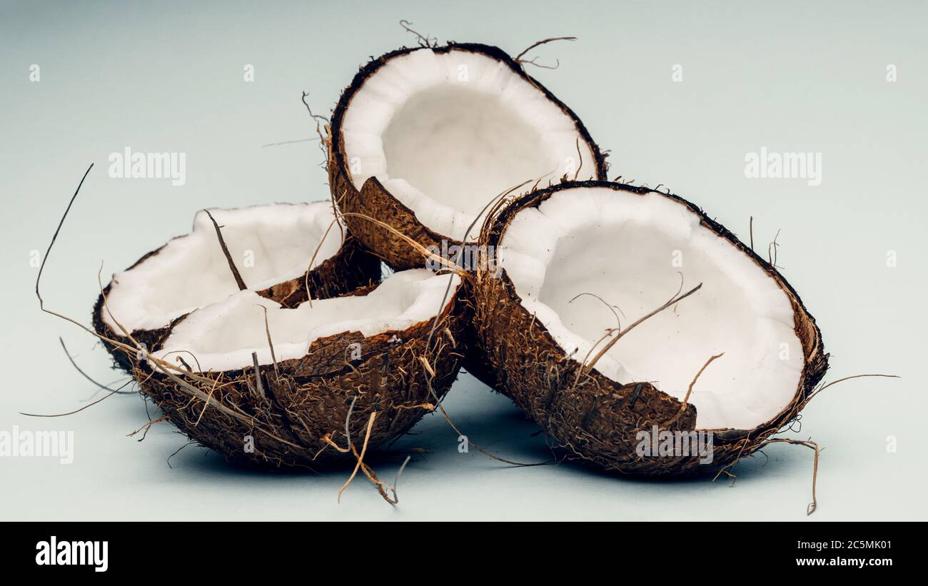 Parts of coconut on a colored background. Close up. Fresh ripe coconut ...