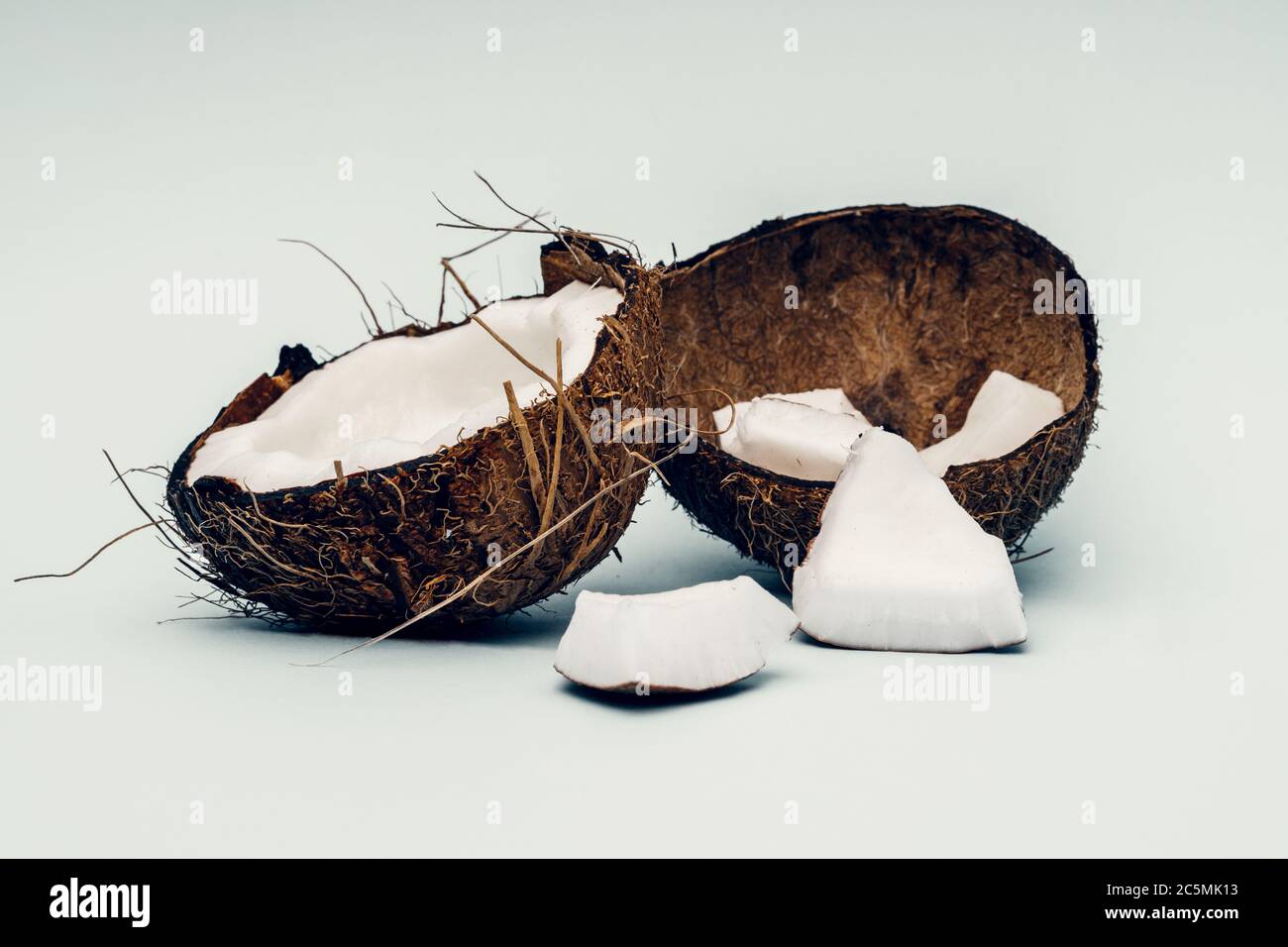 Parts of coconut on a colored background. Close up. Fresh ripe coconut ...