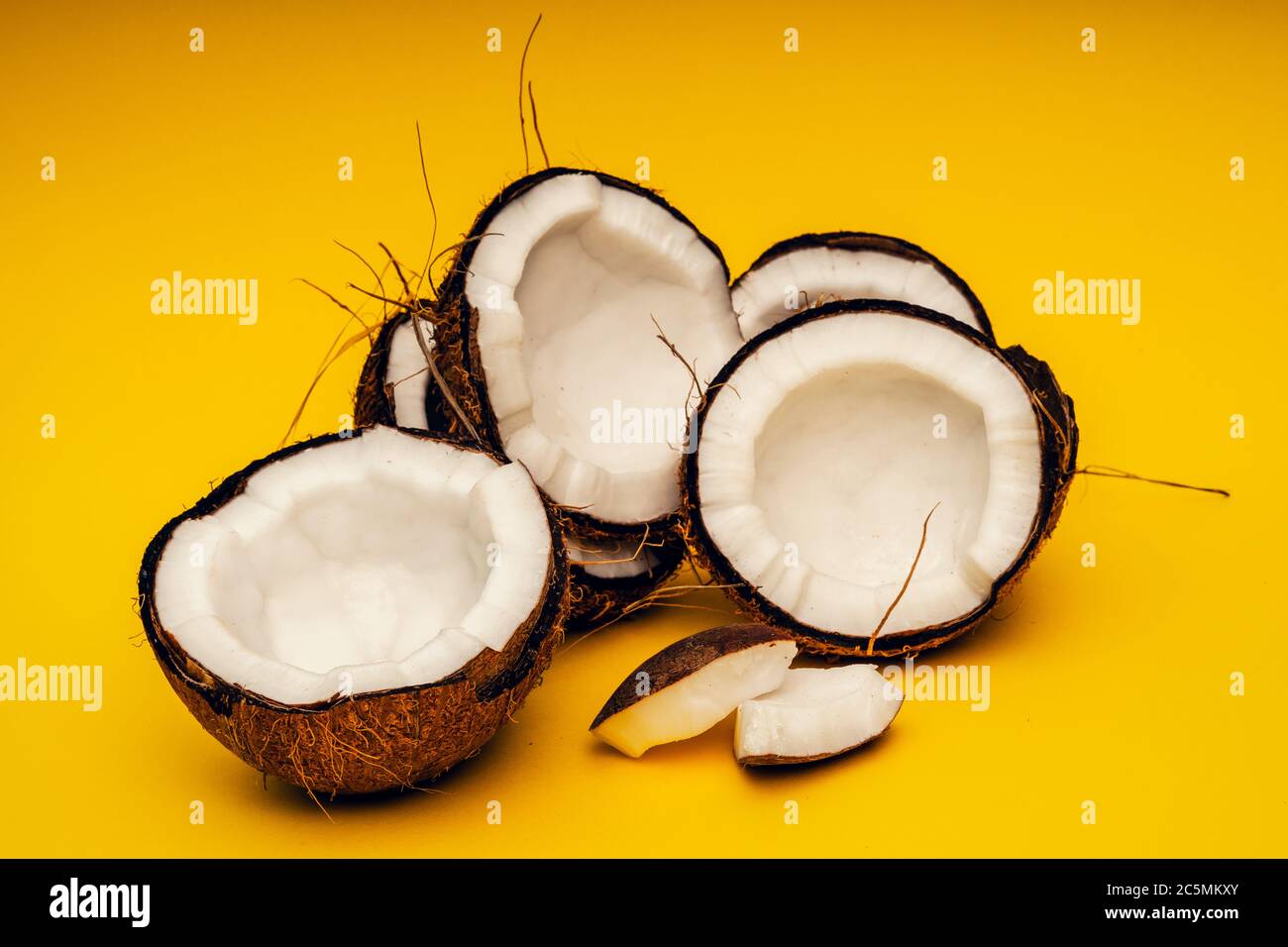 Parts of coconut on a colored background. Close up. Fresh ripe coconut ...