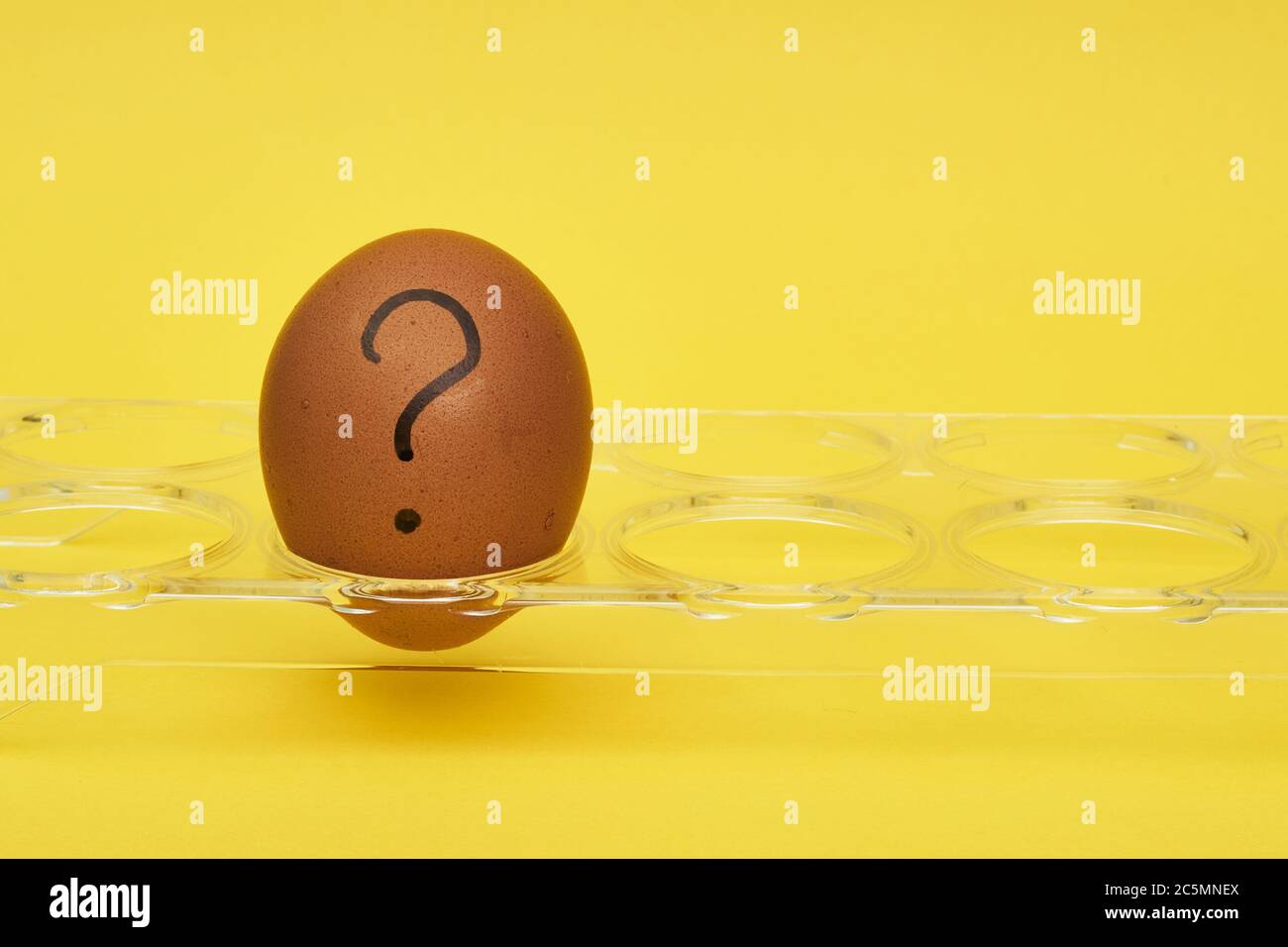 Chicken eggs in an egg stand. Tray for eggs. Half an egg, egg yolk ...