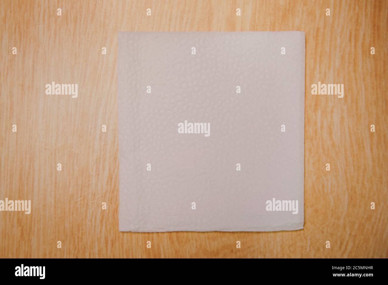 Blank paper napkin isolated on wooden background with copy space ...
