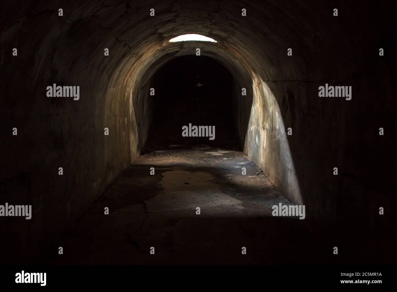 A gloomy, scary mystical underground passage with a skylight in the ...