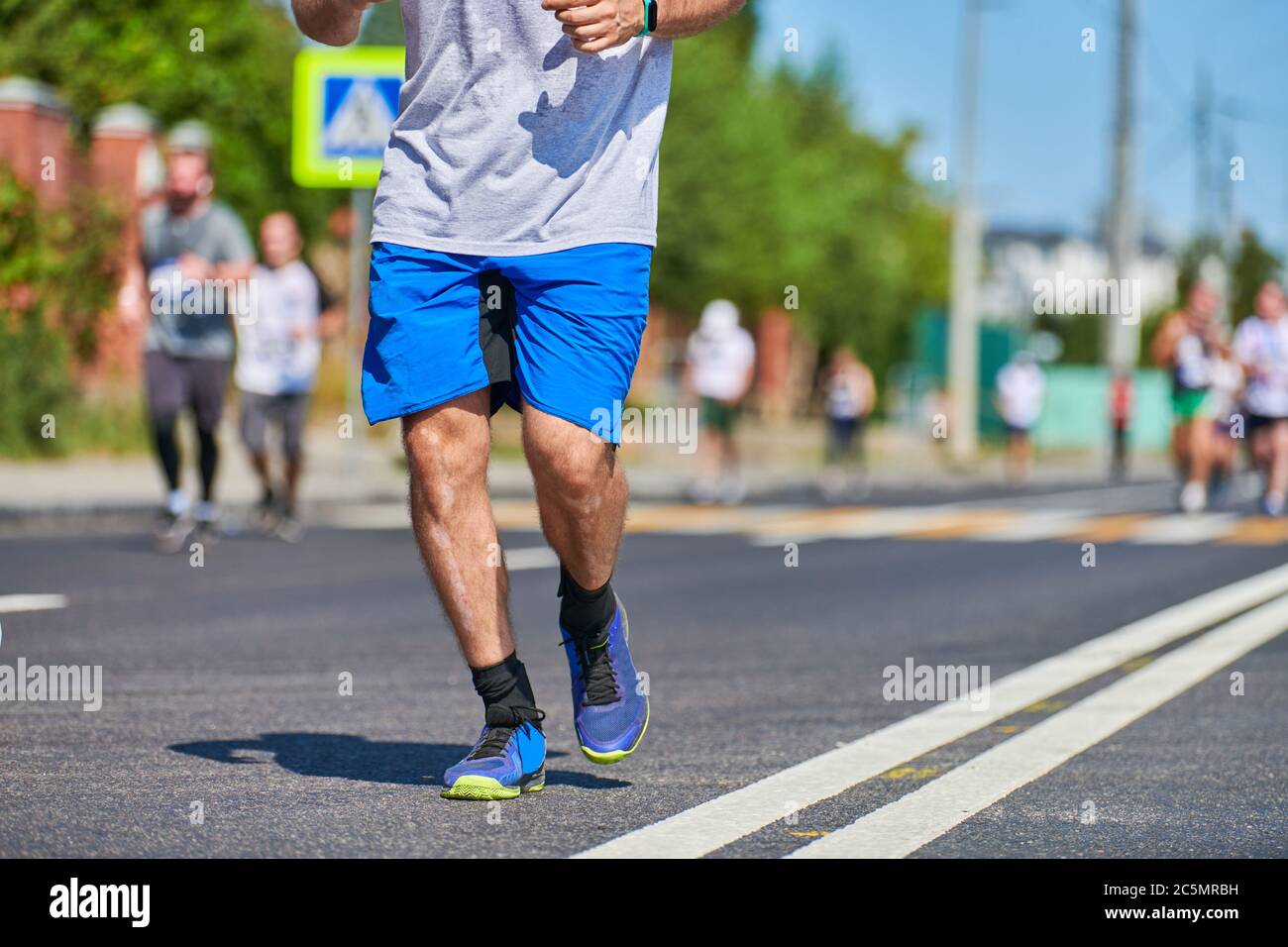 Marathon runners on city road. Running competition. Street sprinting ...