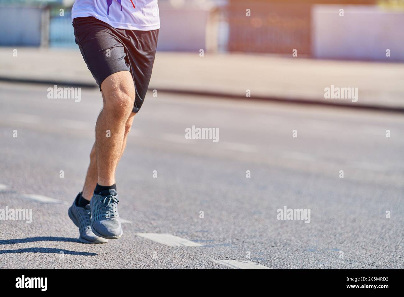 Running man. Athletic man jogging in sportswear on city road. Healthy ...
