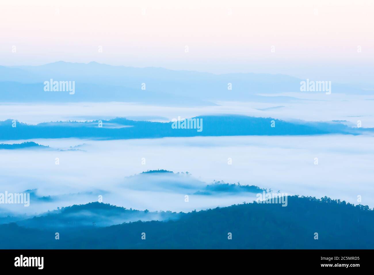 Serene scenery of mountain range on winter morning, soft mist covered ...