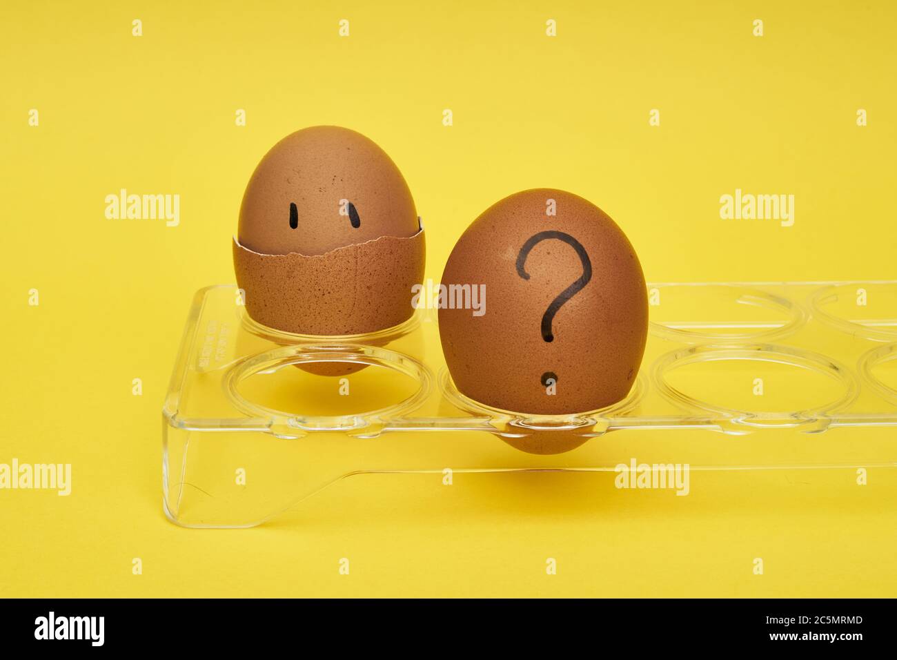 Chicken eggs in an egg stand. Tray for eggs. Half an egg, egg yolk ...