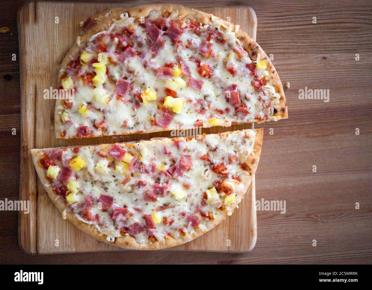Delicious italian pizza served on wooden table. cutted pizza slices ...
