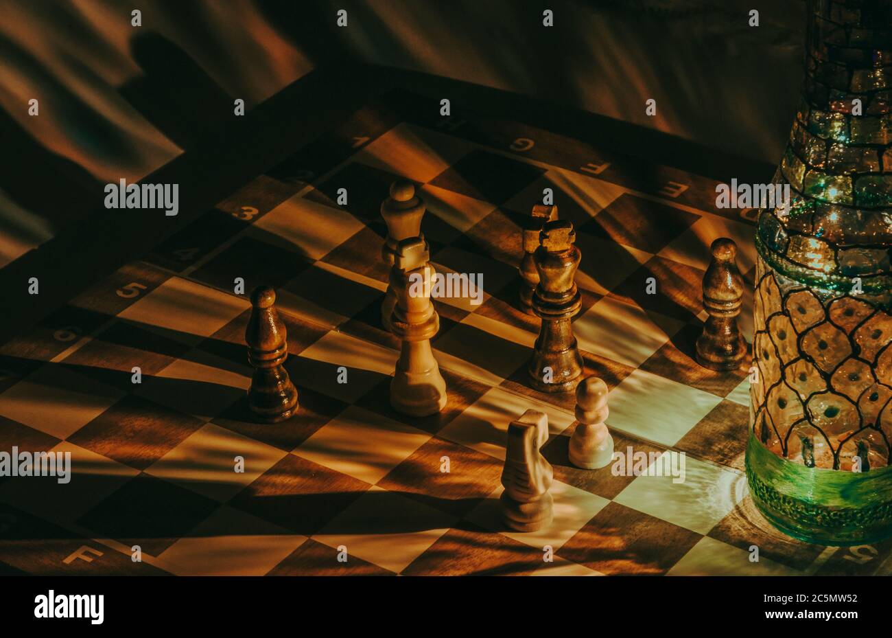 Light on the chess board and coins Stock Photo - Alamy