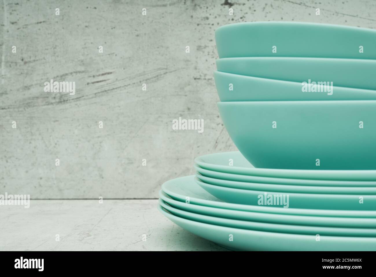A stack of dishes on a light background. Glass set of dishes for the ...