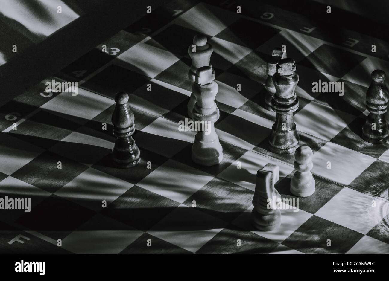 Light on the chess board and coins Stock Photo - Alamy