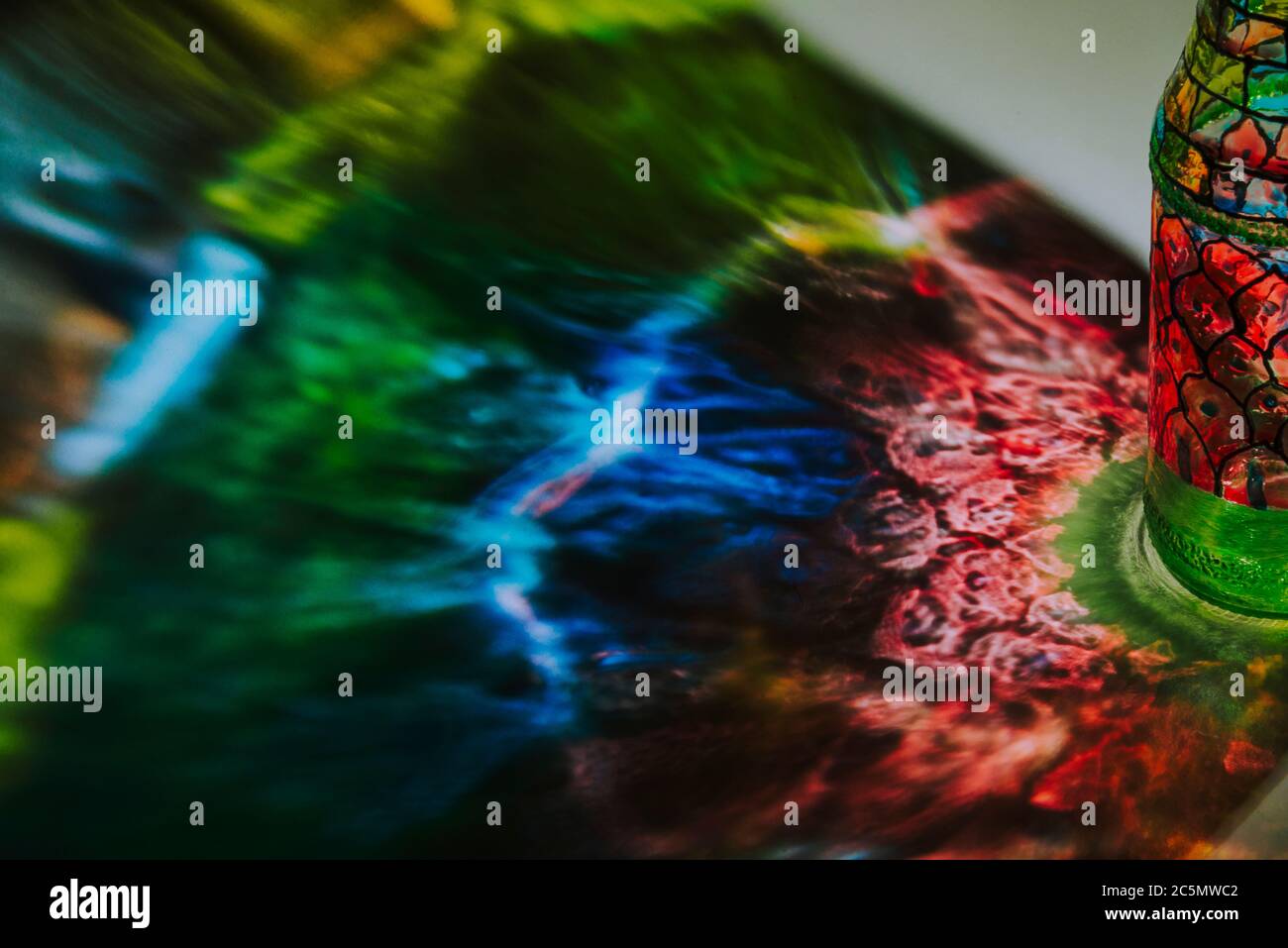 light passing through an bottle with colored art Stock Photo - Alamy