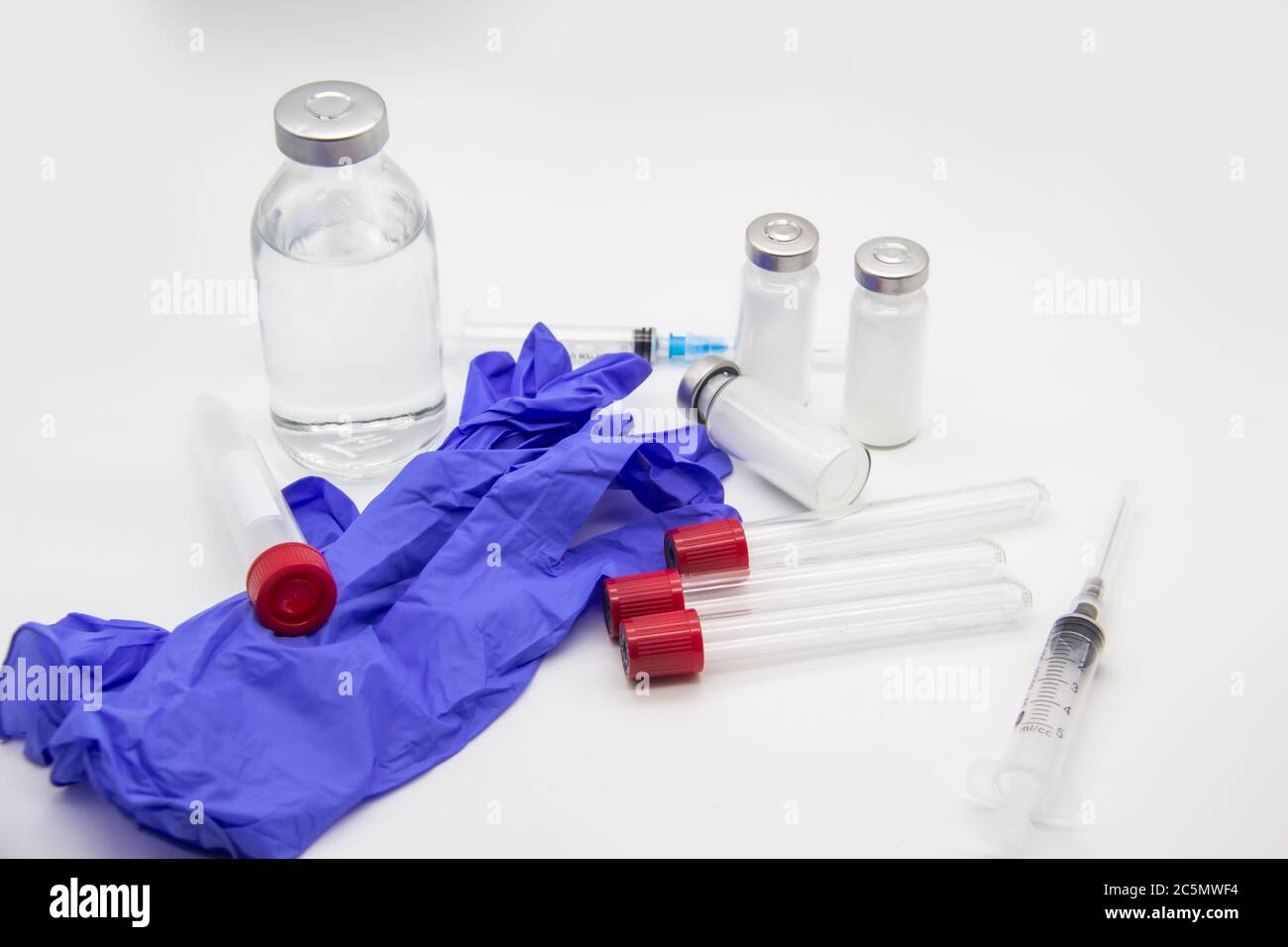 On the table are medical items and injection syringe,empty test tubes ...