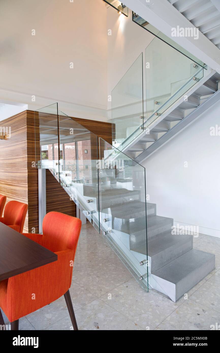 View of stairs and dining room inside modern and luxurious apartment ...