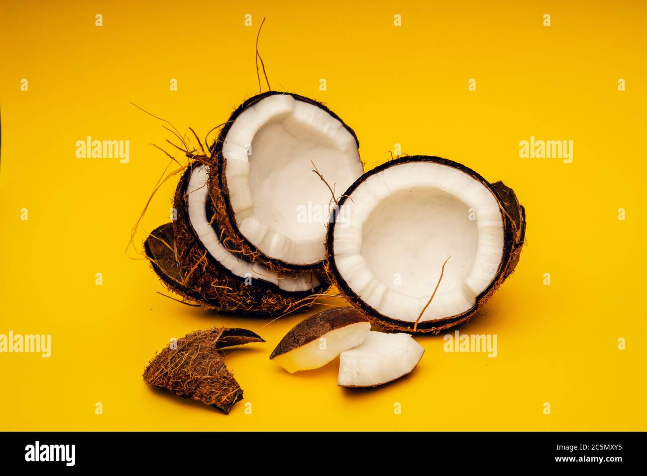 Parts of coconut on a colored background. Close up. Fresh ripe coconut ...