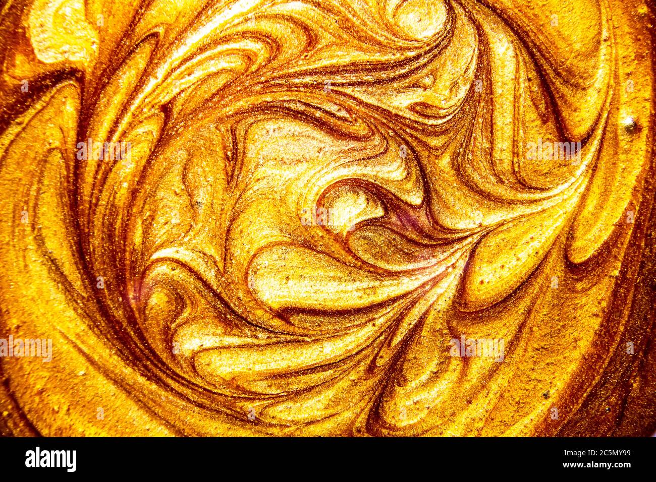 A golden abstracted and textured paint art. Liquid golden drawing and ...