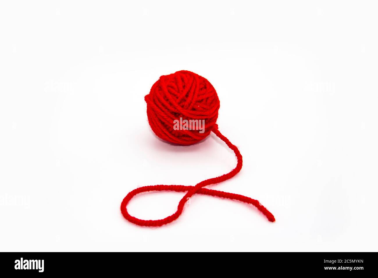 Red skein of thread against white background. Red ball of wool red ...