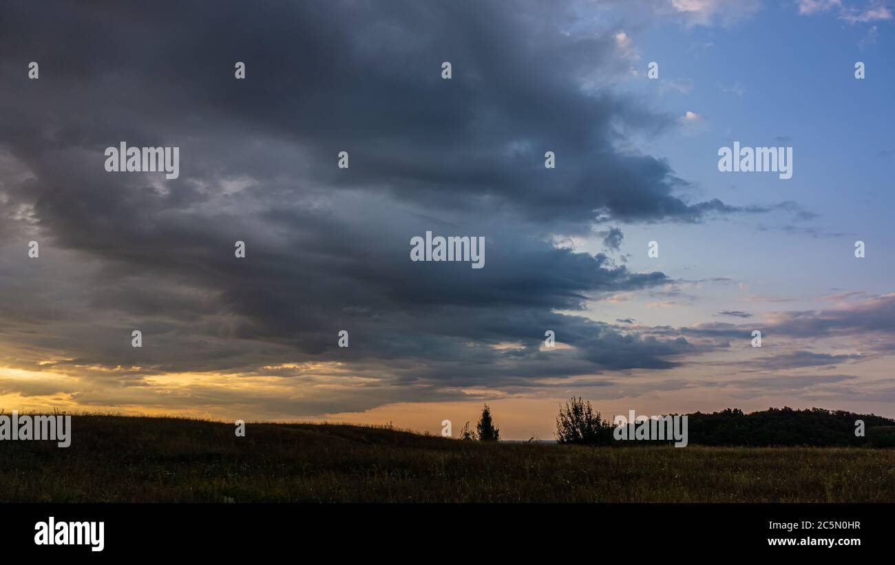 Evening sky and rain clouds, countryside landscape. Summer season ...