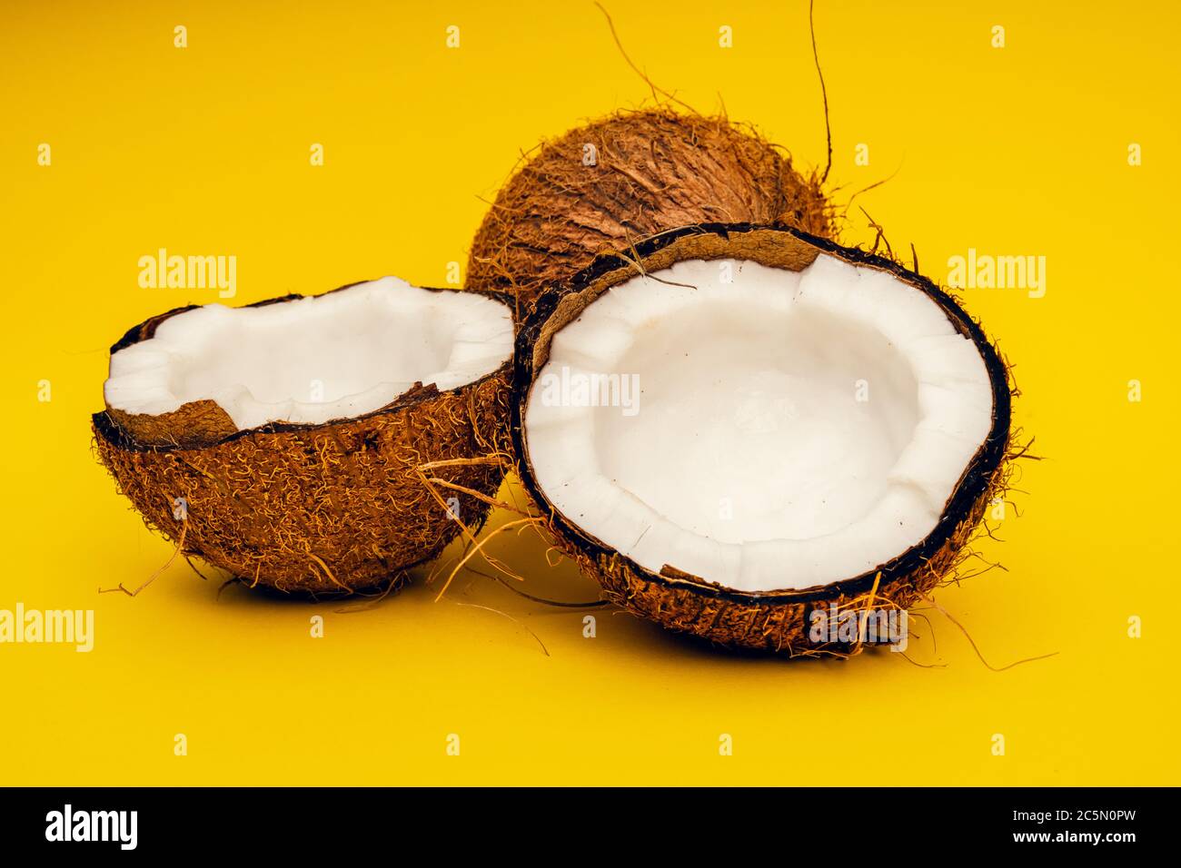 Parts of coconut on a colored background. Close up. Fresh ripe coconut ...