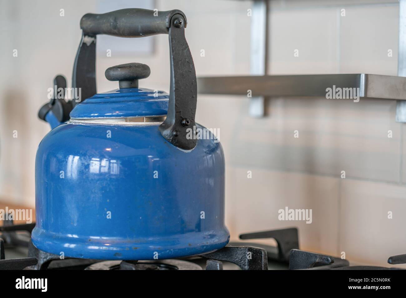 Old vintage blue kettle in the kitchen Stock Photo - Alamy