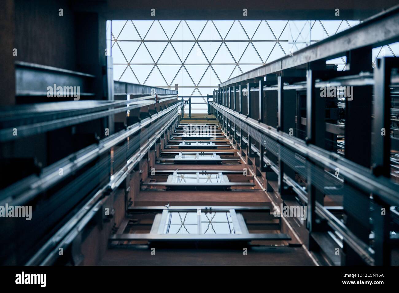 Open elevator lift shaft. Modern architecture with transparent ceiling ...
