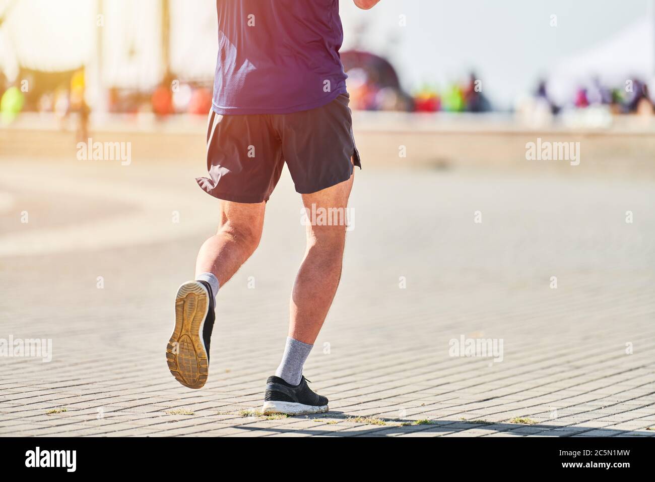 Running man. Athletic man jogging in sportswear on city road. Healthy lifestyle, fitness sport ...