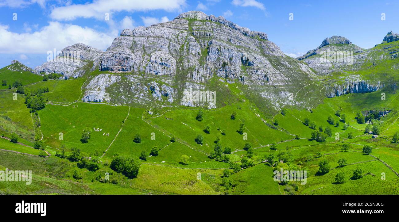Spring landscape of mountains, meadows of mowing and cabins pasiegas in ...