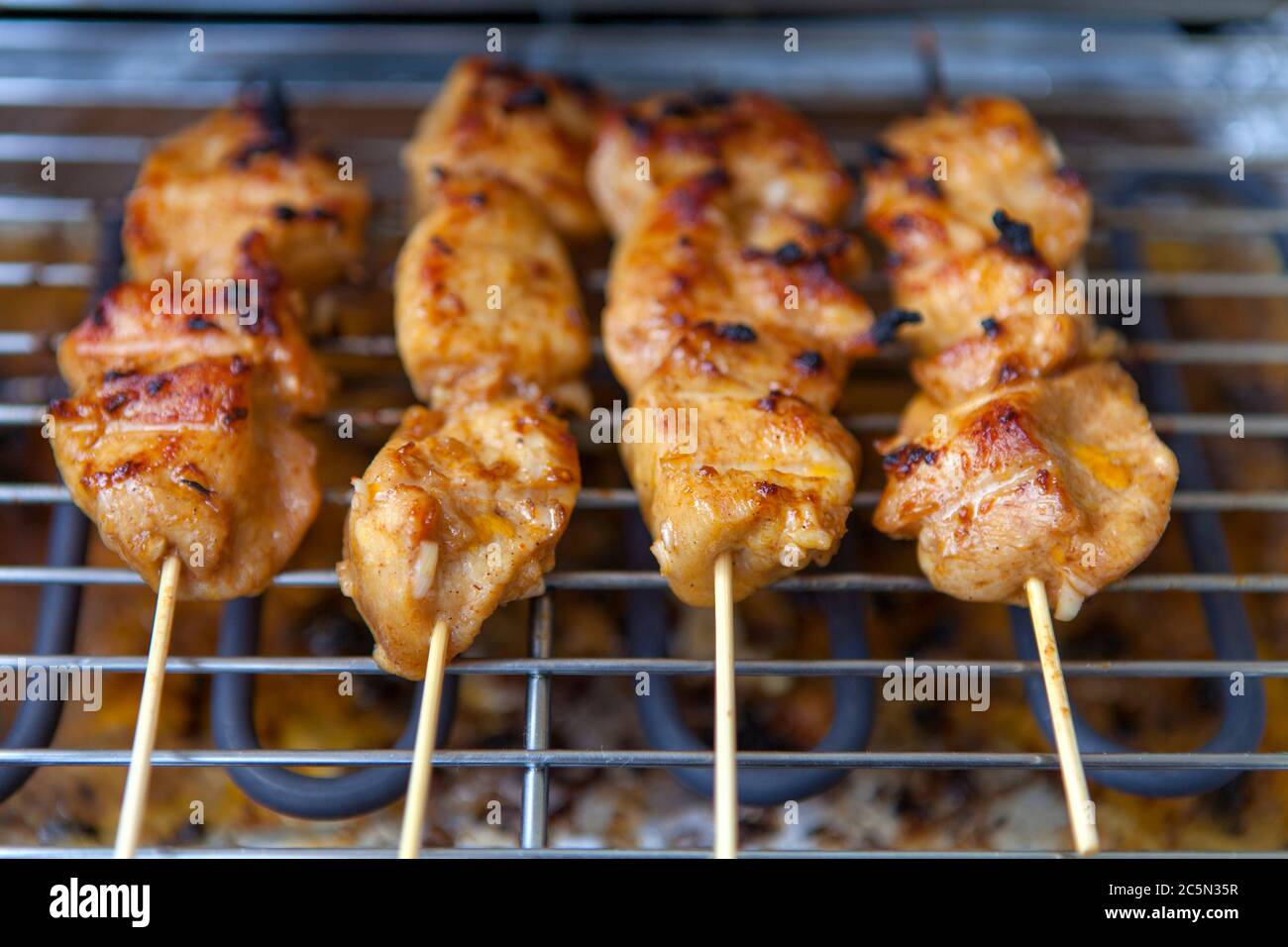 Delicious grilled chicken sate on BBQ Stock Photo - Alamy