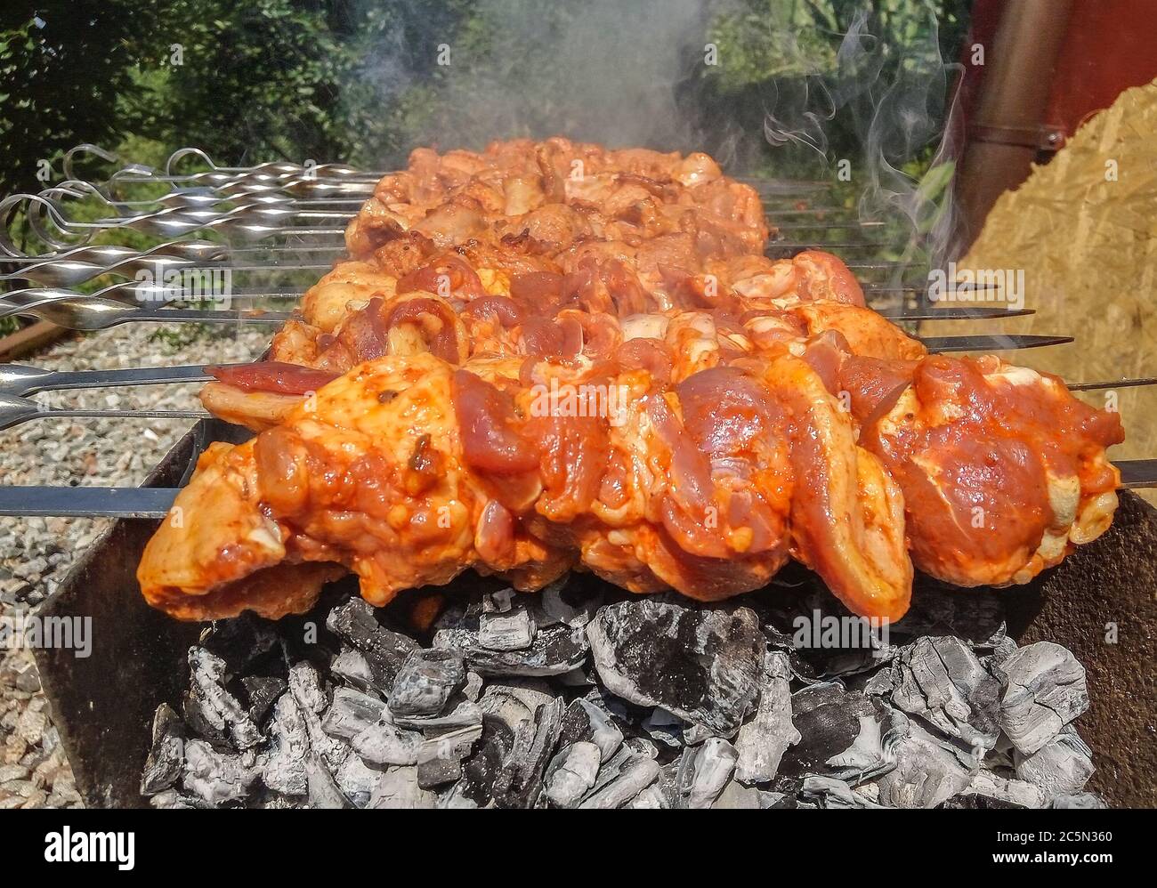Grilled kebab (Roasted meat) cooking on metal skewer closeup ...