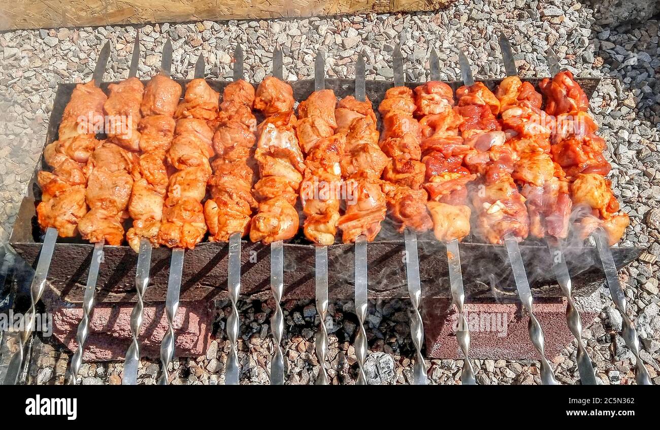 Grilled kebab (Roasted meat) cooking on metal skewer closeup ...