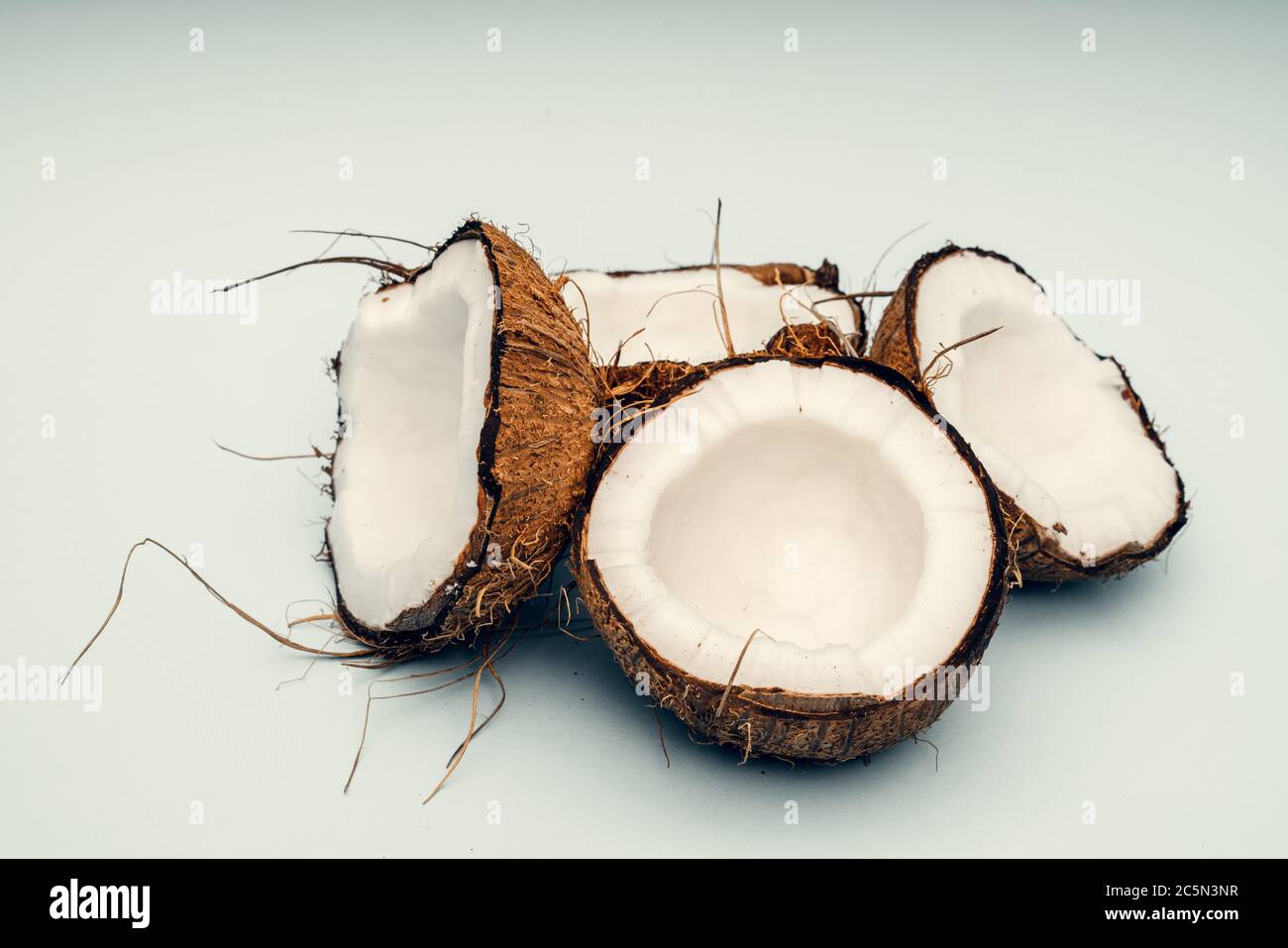 Parts of coconut on a colored background. Close up. Fresh ripe coconut ...