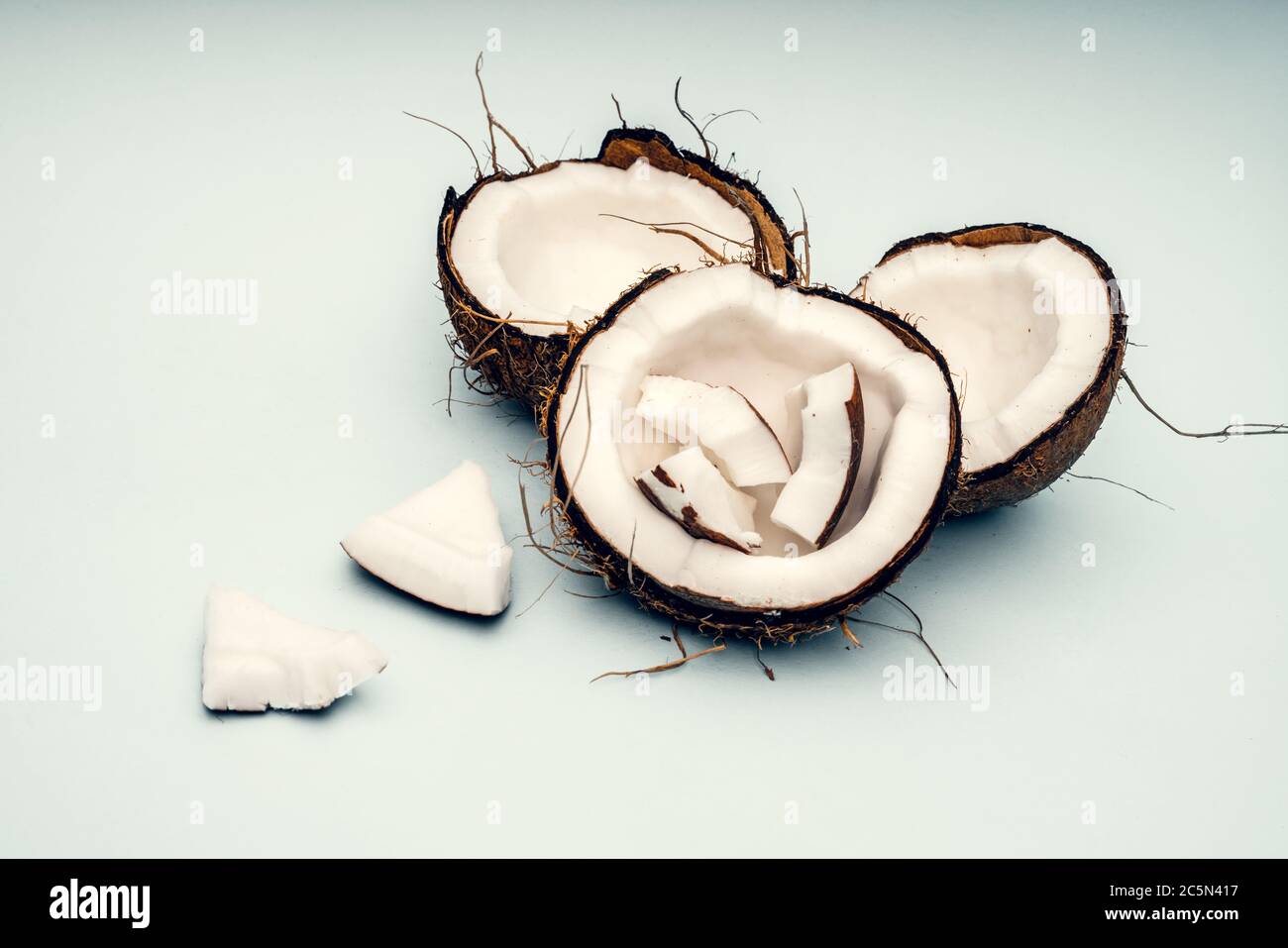 Parts of coconut on a colored background. Close up. Fresh ripe coconut ...