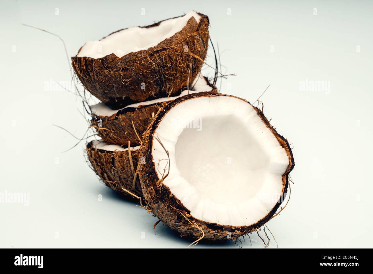 Parts of coconut on a colored background. Close up. Fresh ripe coconut ...