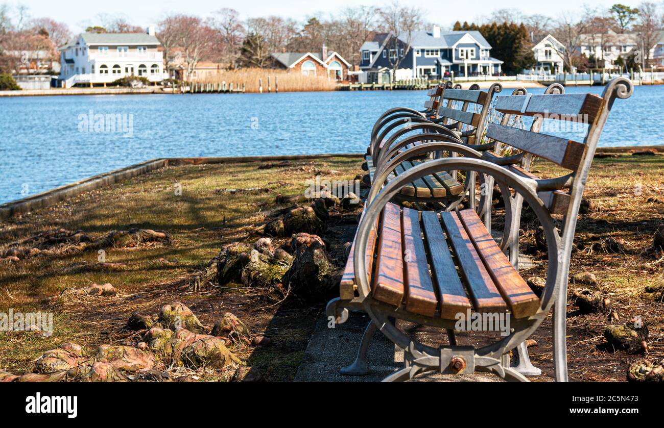 Three park benches side by side overlooking the connetquot river in the ...