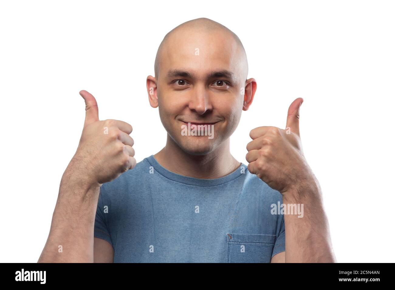 Photo of young bald showing thumb man in blue tee shirt Stock Photo - Alamy