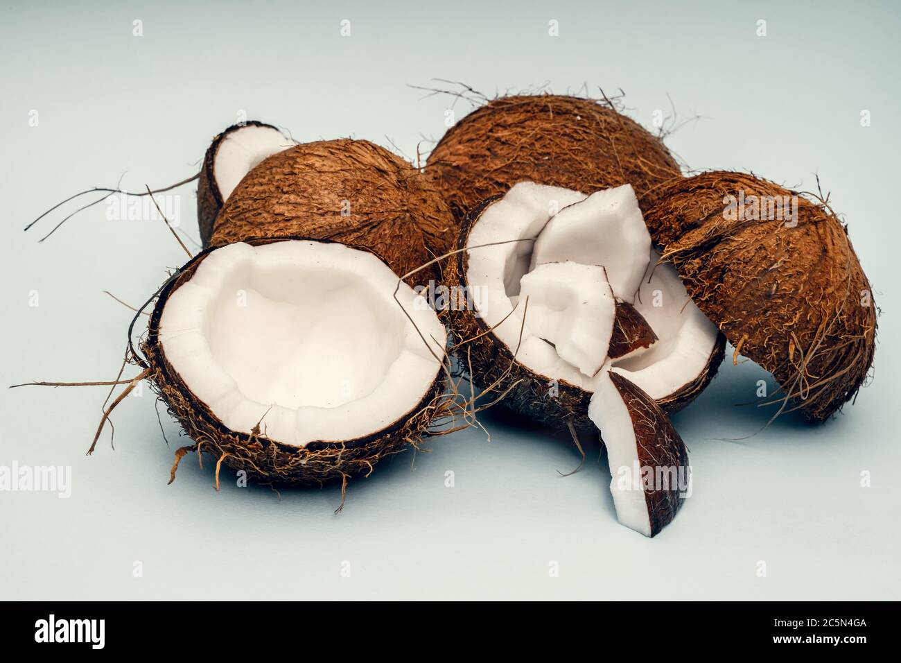 Parts of coconut on a colored background. Close up. Fresh ripe coconut ...