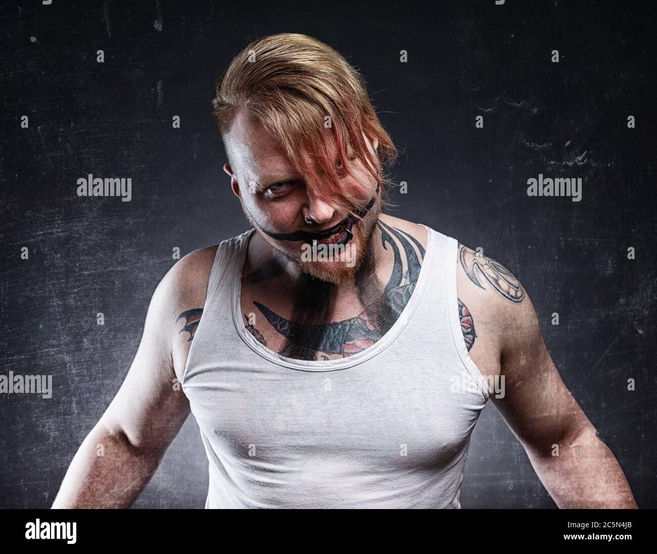 Picture of a tattooed scary mad man with horror make-up Stock Photo - Alamy