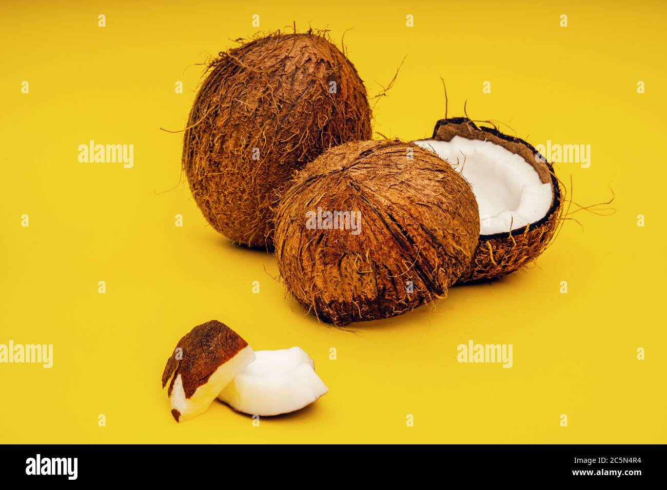 Parts of coconut on a colored background. Close up. Fresh ripe coconut ...