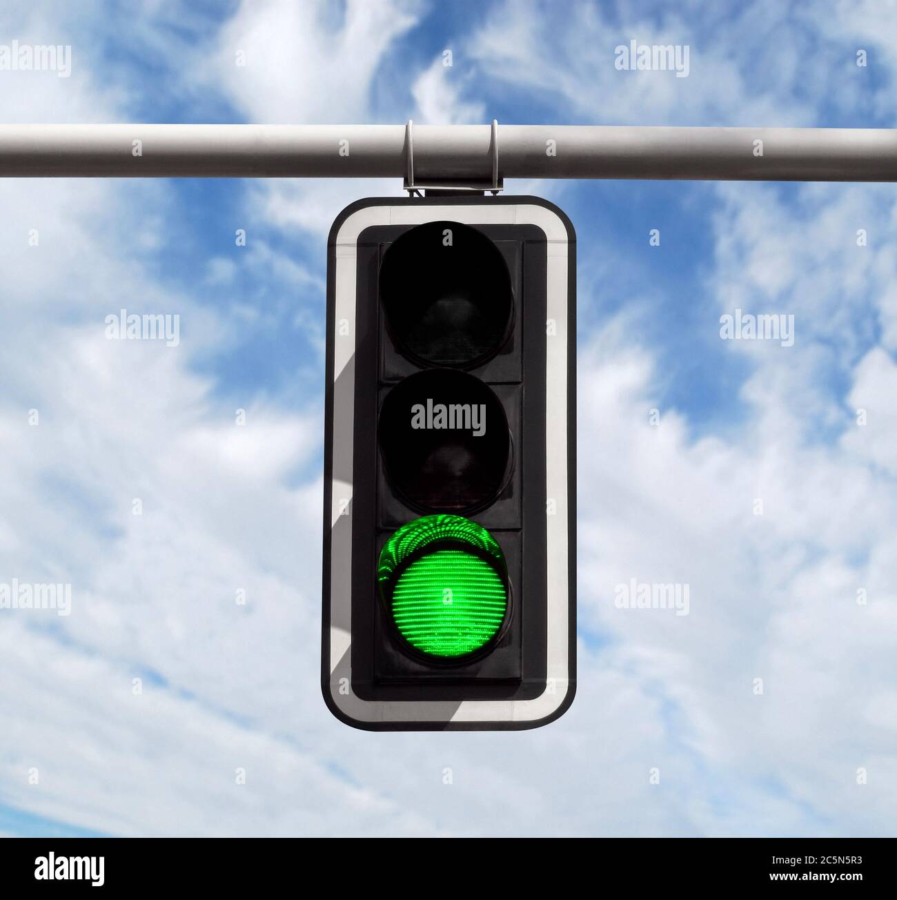 Green traffic light against blue sky background with Clipping Path ...