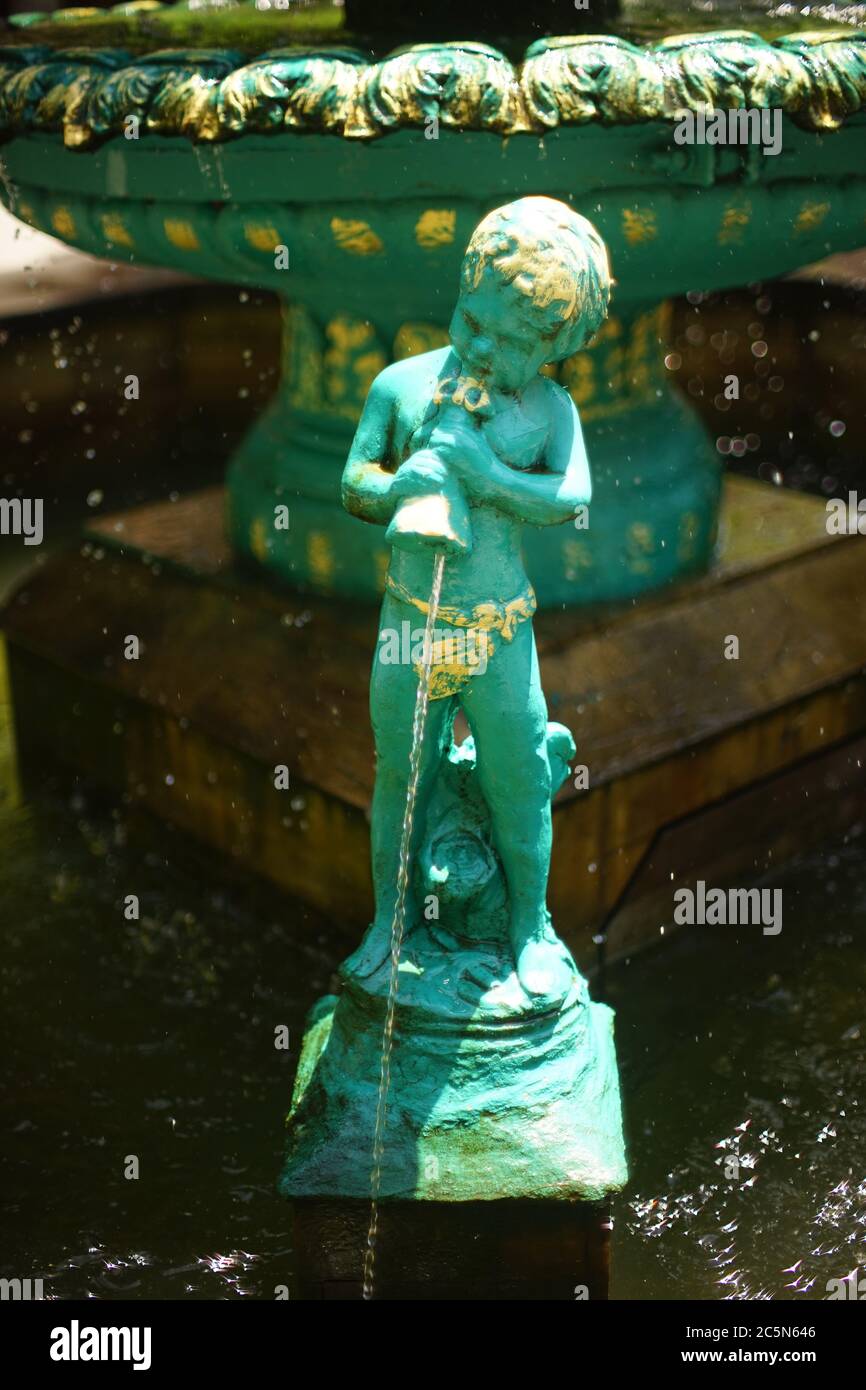 Fountain with green marble statue of angel pouring water from jug Stock ...